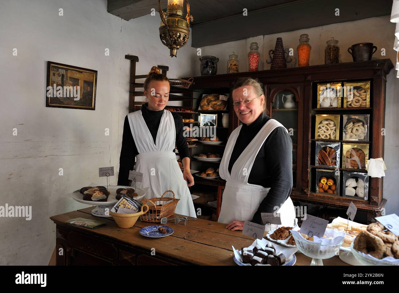 Museum staff members dress up in historical authentic clothing at Den Gamle By or The Old Town ...