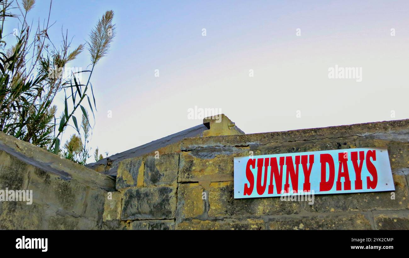 Sunny Days sign in desolate surroundings on Gozo, Malta Stock Photo - Alamy