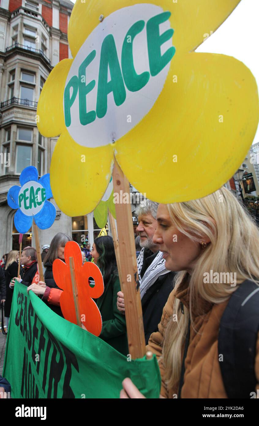 London, England, UK. 16th Nov, 2024. A protester holds a flower shaped ...