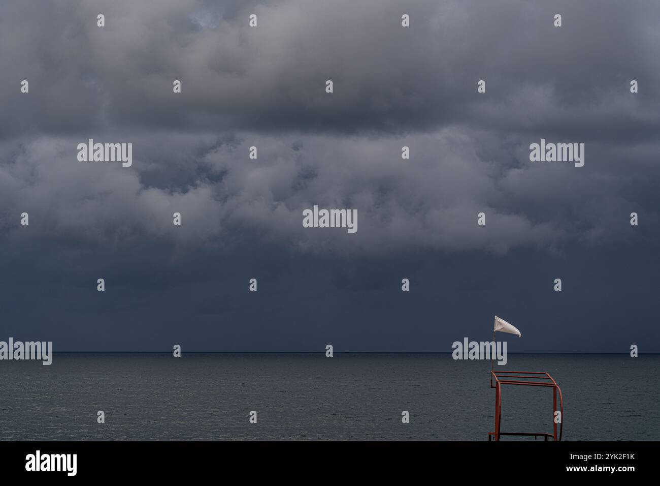 White flag on the sea beach guard tower Stock Photo - Alamy