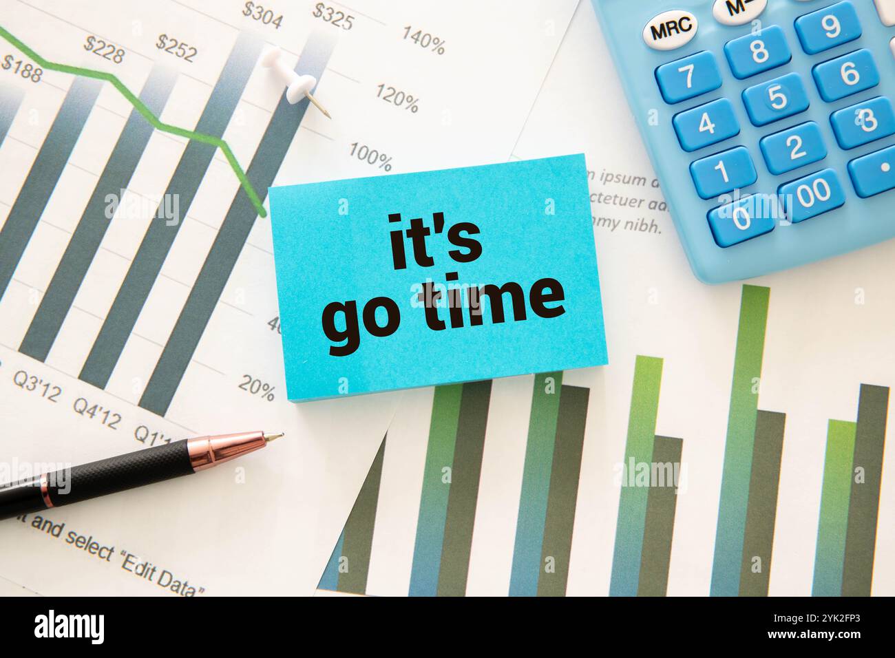 text IT'S GO TIME on easel with office tools and paper.Top view ...