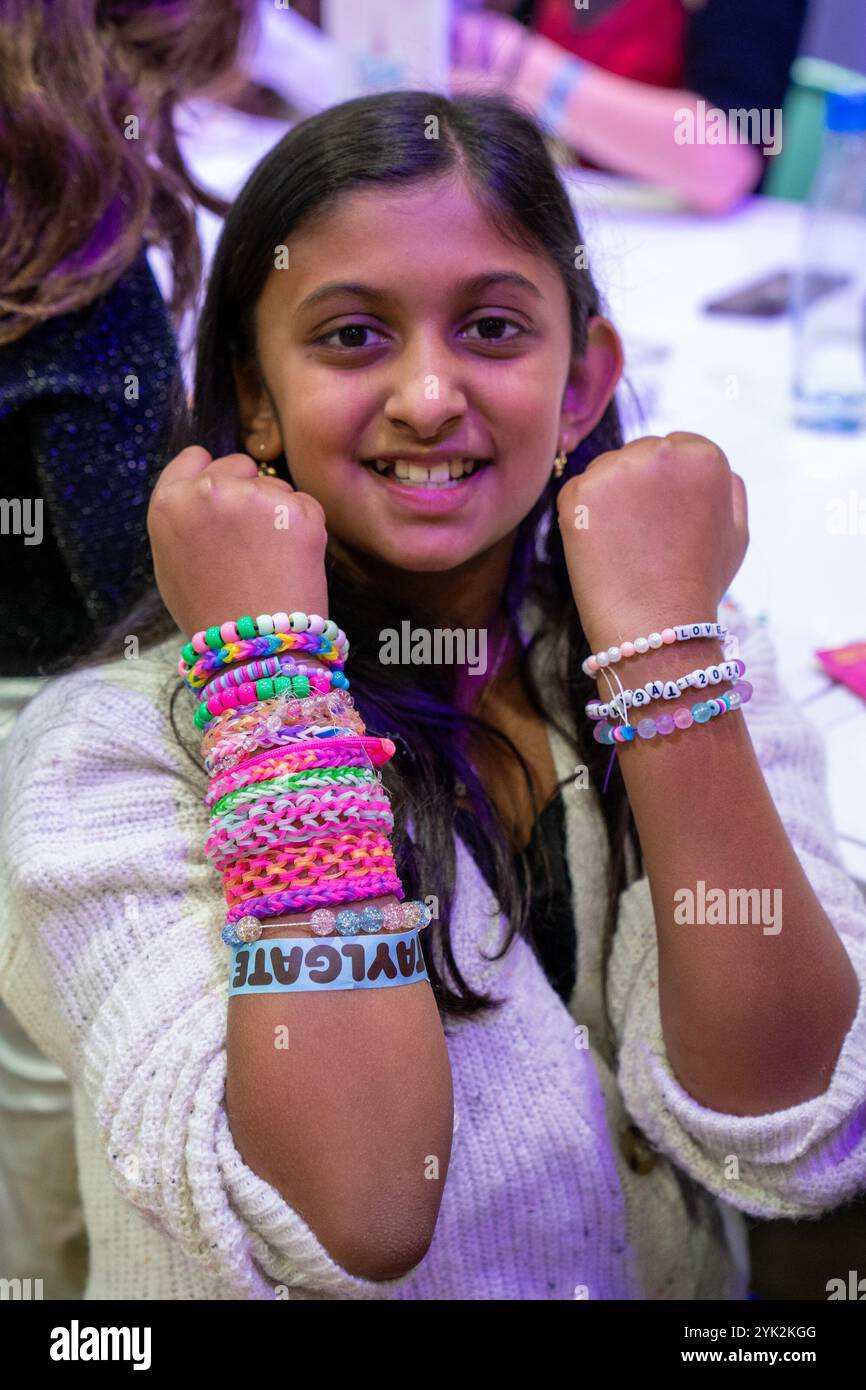 Swiftie shows off bracelets she made at the Bracelet Exchange station ...