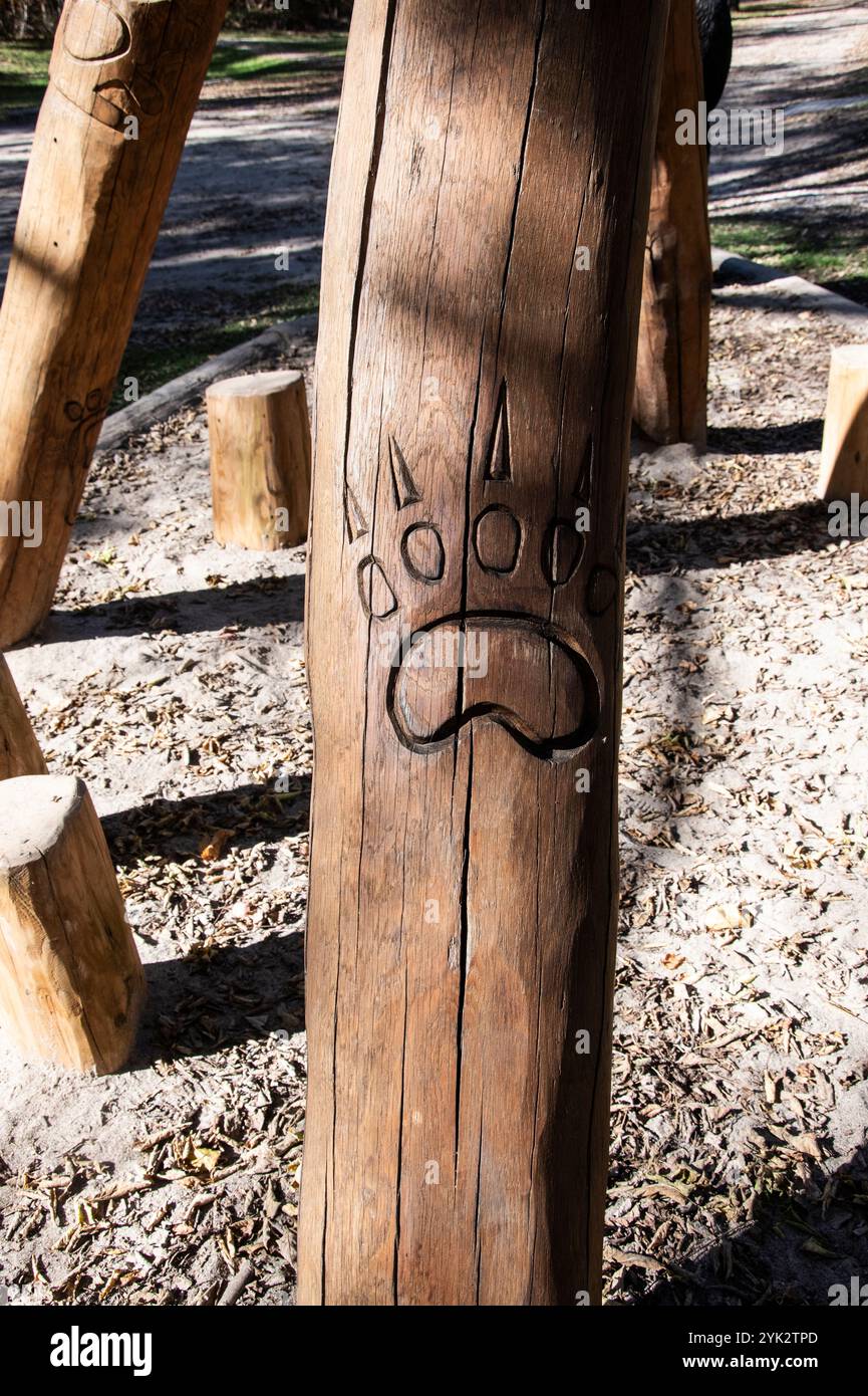 Bear paw carved in a log at Madbin Jina at Point Pelee National Park in ...