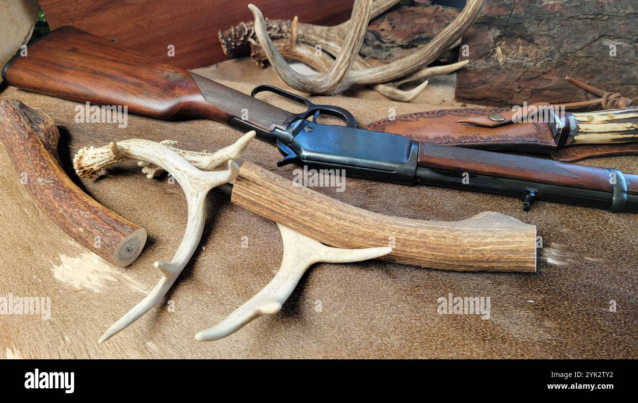 View of a lever action Rifle with deer antlars and a hunting knife on ...