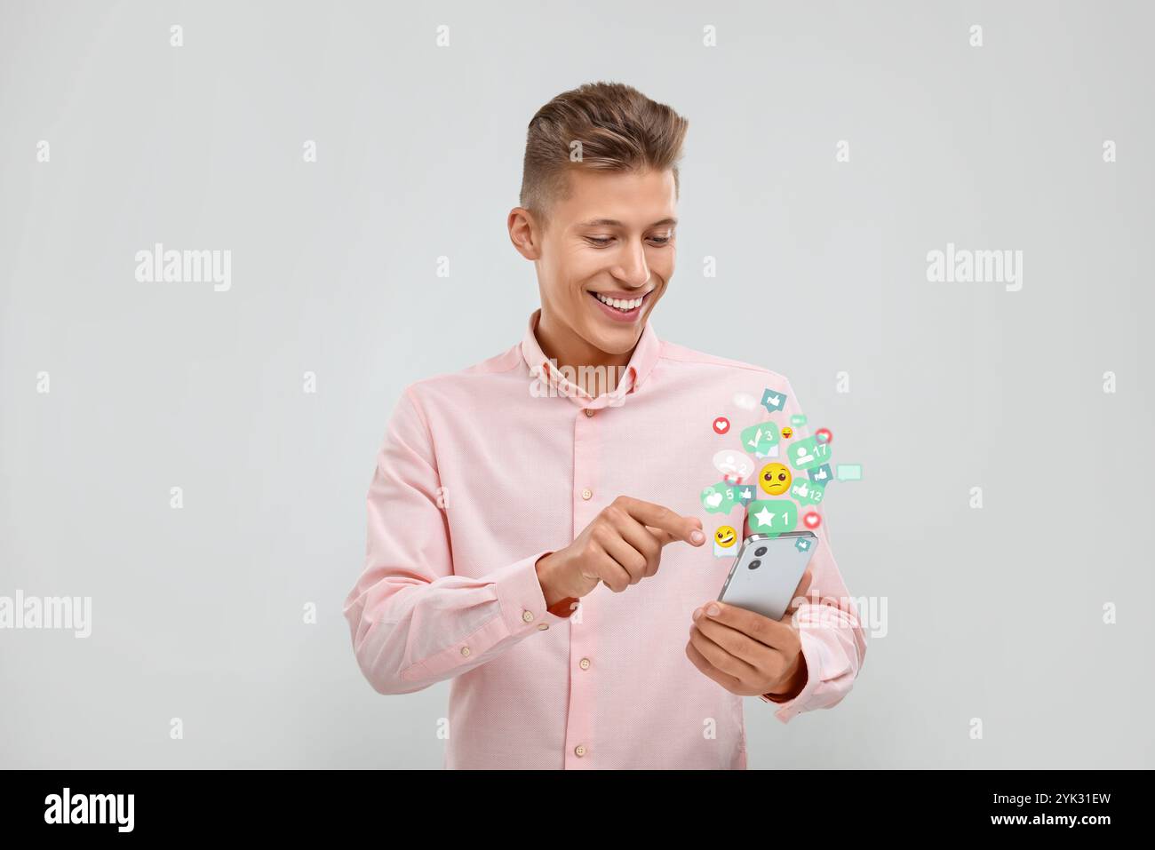 Happy man using mobile phone on white background. New message sign and ...