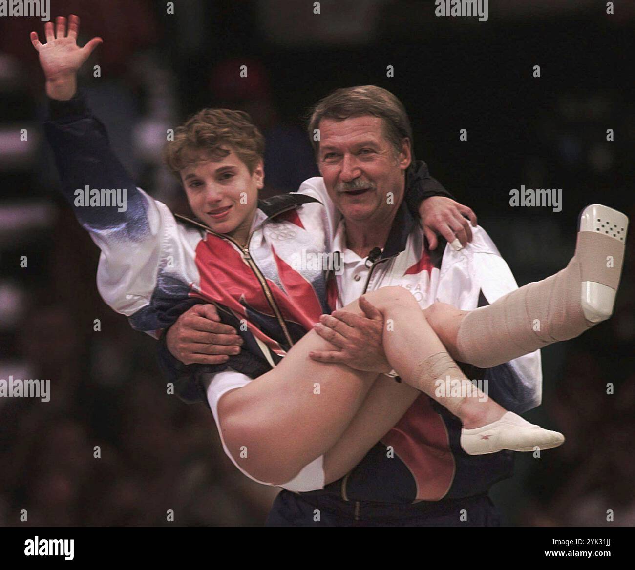 FILE - USA's Kerri Strug is carried by her coach, Bela Karolyi, as she ...