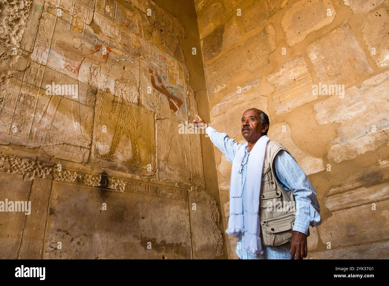 Mamdouh Kamel, Egyptian guide, deciphering the meaning of the painted ...