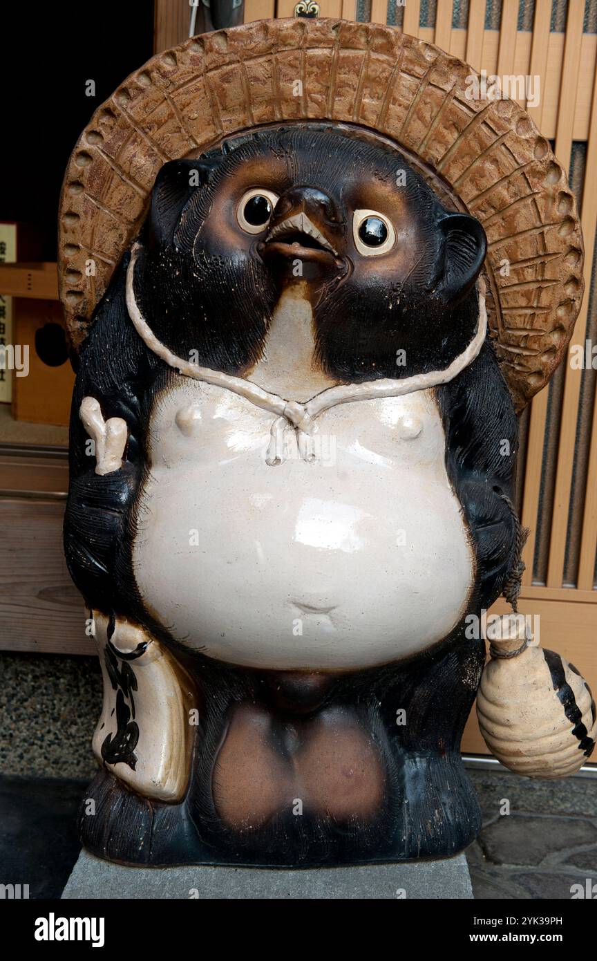 A tanuki (raccoon dog) figure ubiquitous in Japan symbolizing good luck ...