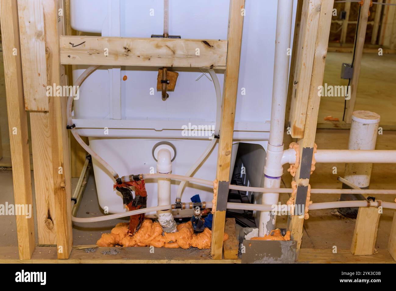 Workers are installing plumbing connecting bath systems inside ...