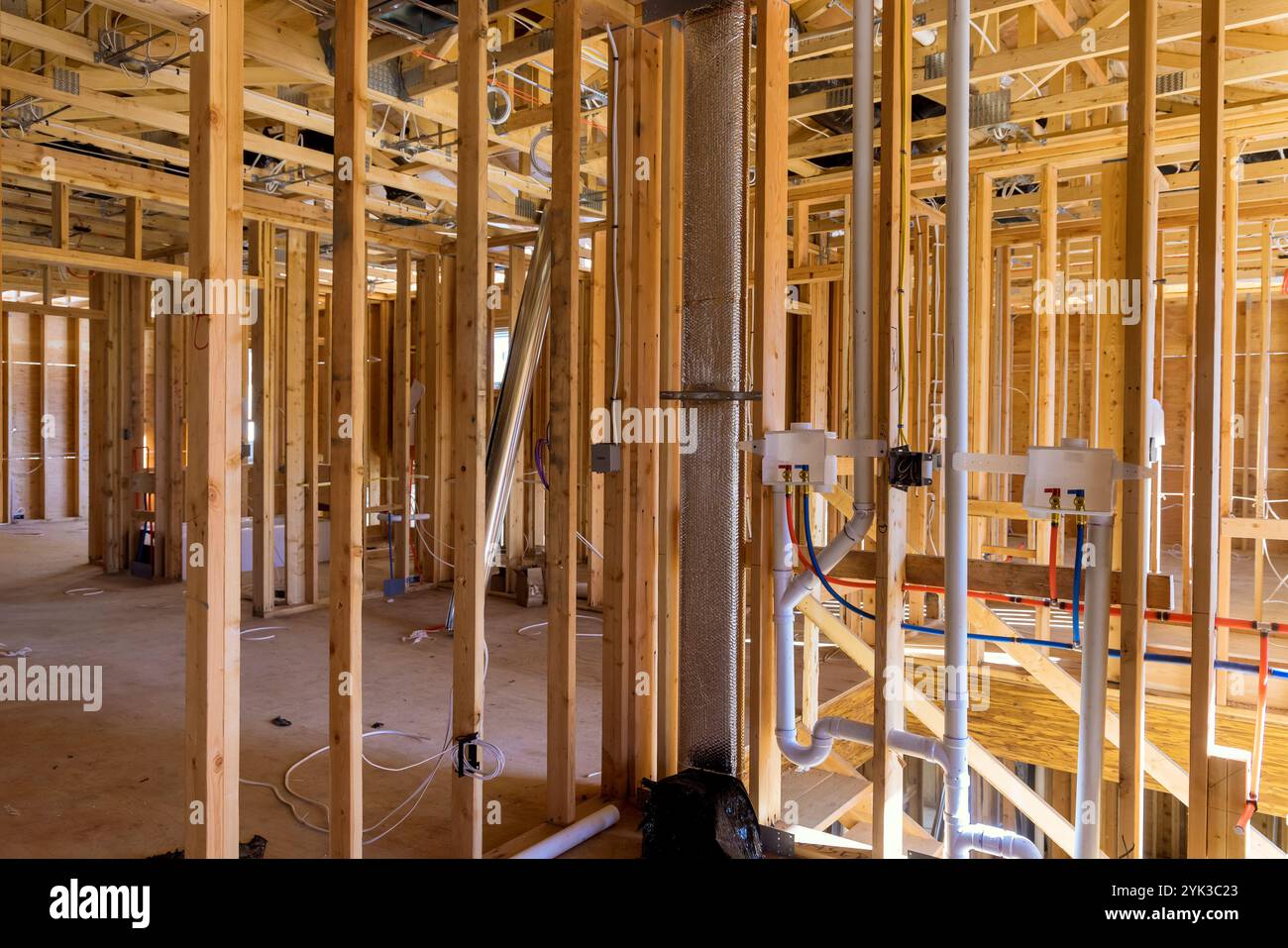Residential building under construction wooden framing, plumbing ...