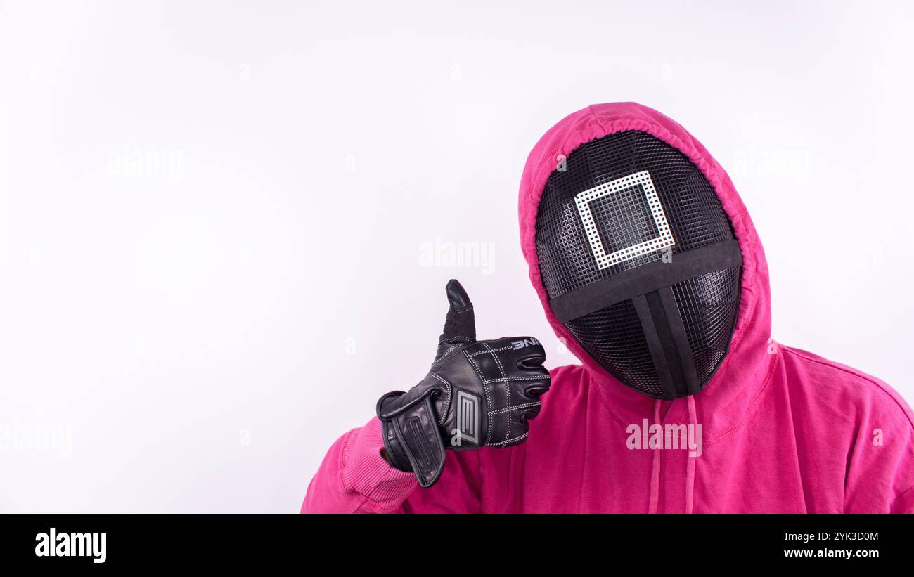 Squid Game red guard with thumbs up sign on white background. Space for ...