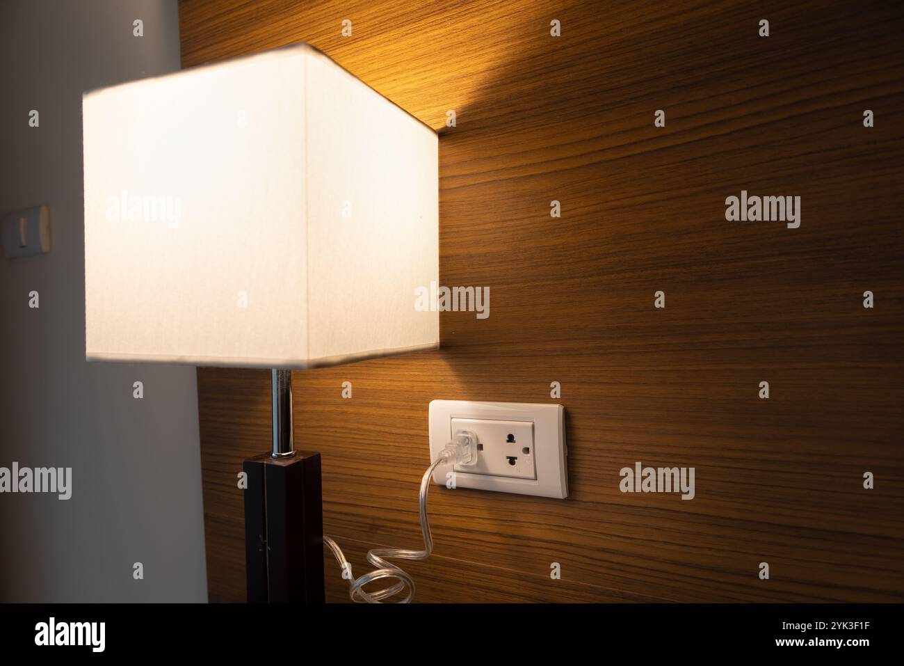 Close Up table lamp electrical power socket and plug socket on wall ...