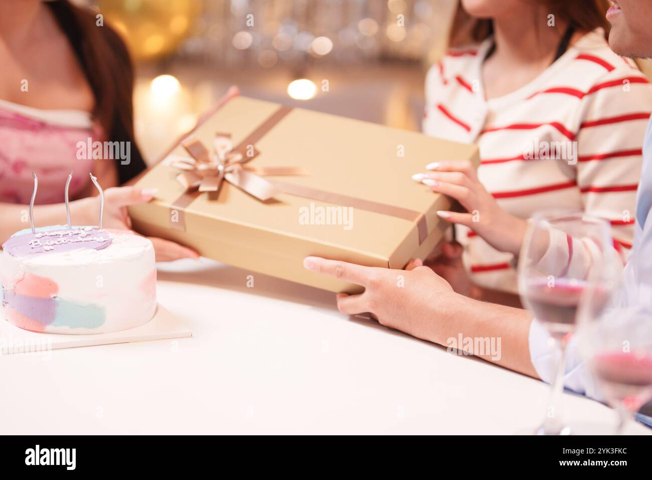 A lively birthday gathering as friends present a surprise gift to the ...