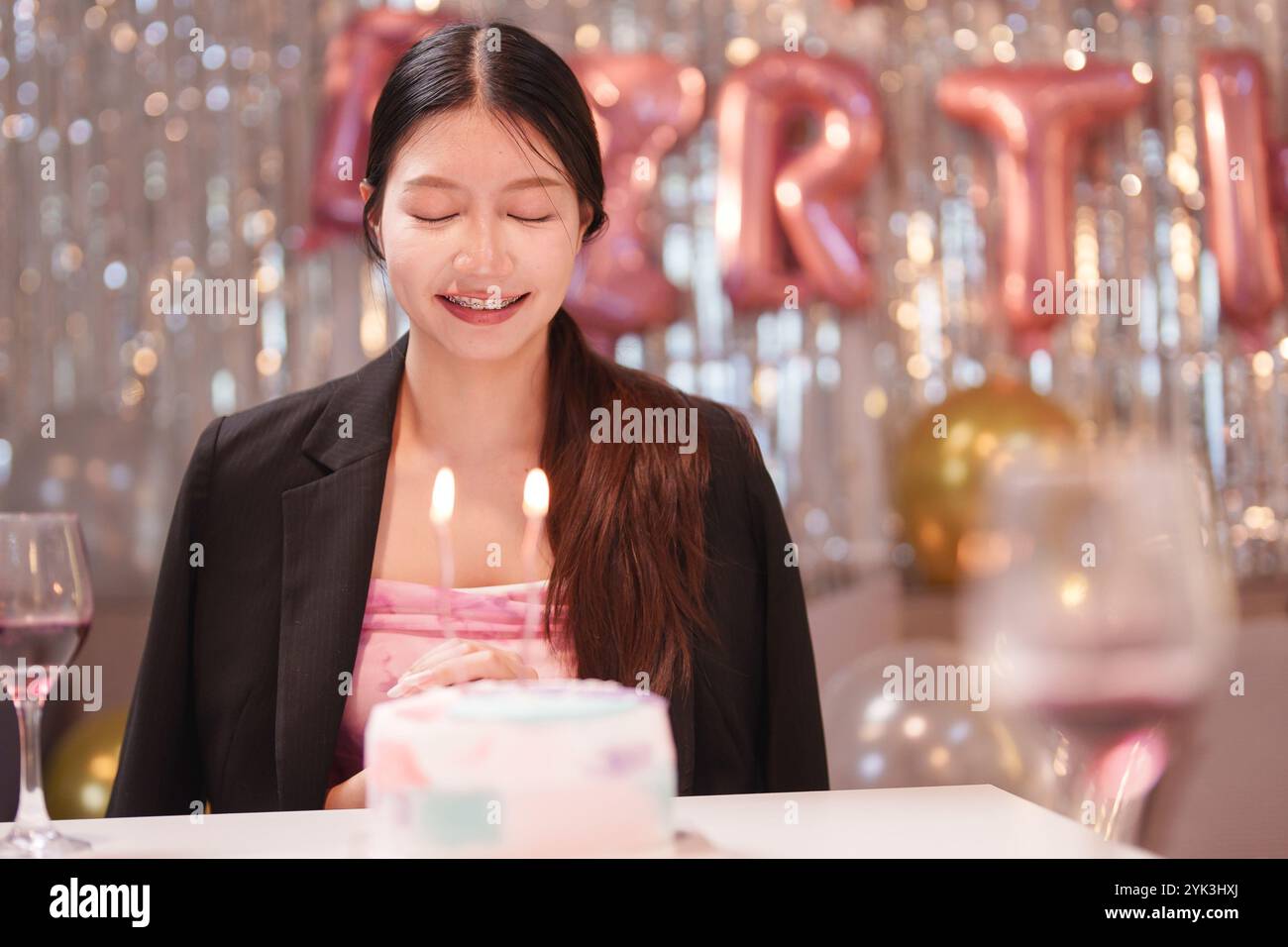 A joyous moment at a birthday party as friends playfully interact while ...