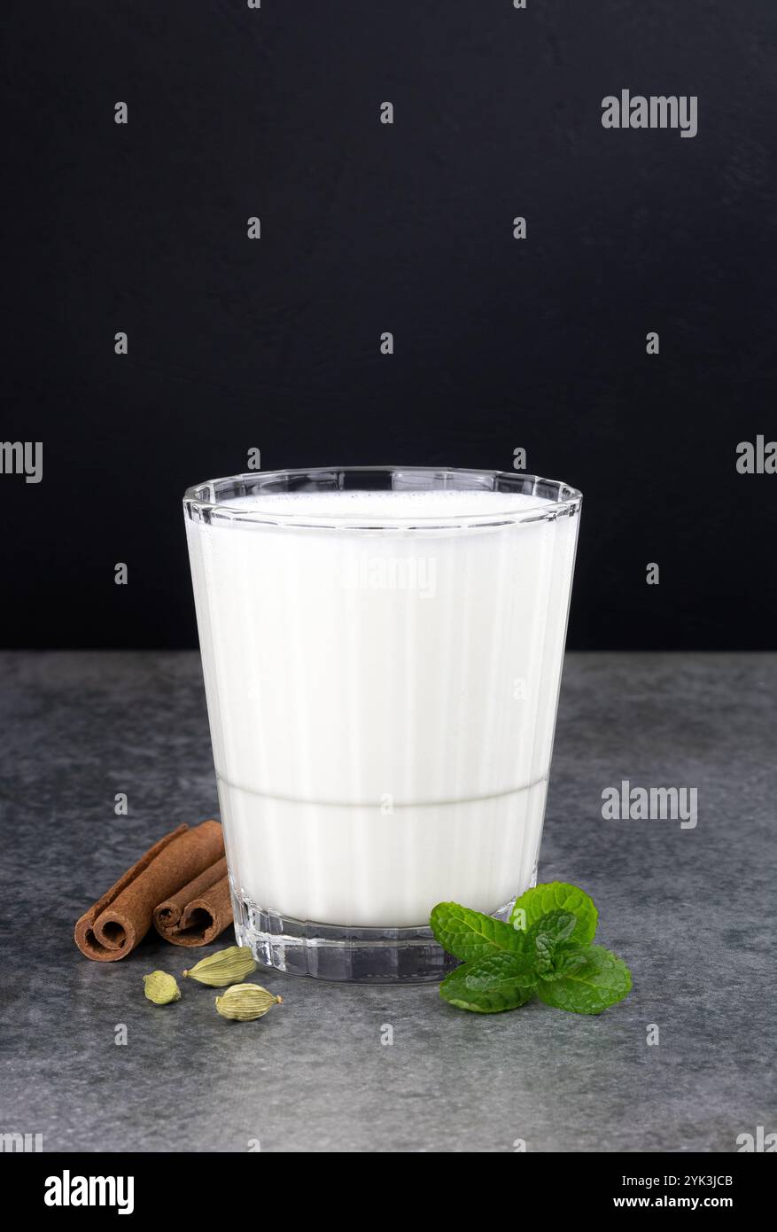A glass of Indian cold drink based on yogurt dahi - Lassi with spices ...