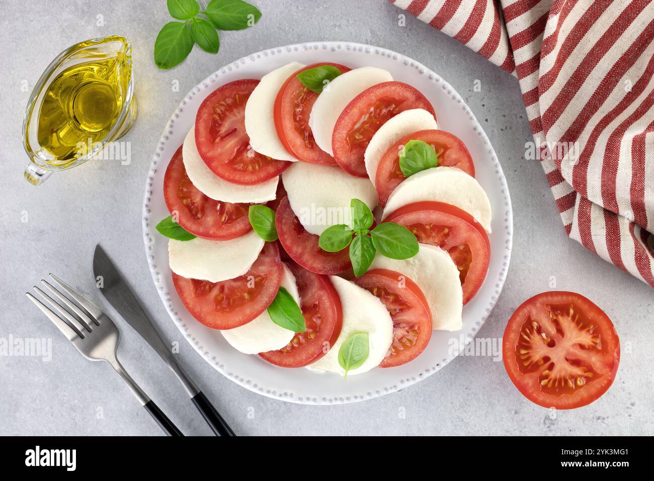 Italian caprese salad with tomatoes, mozzarella, basil, olive oil on a ...