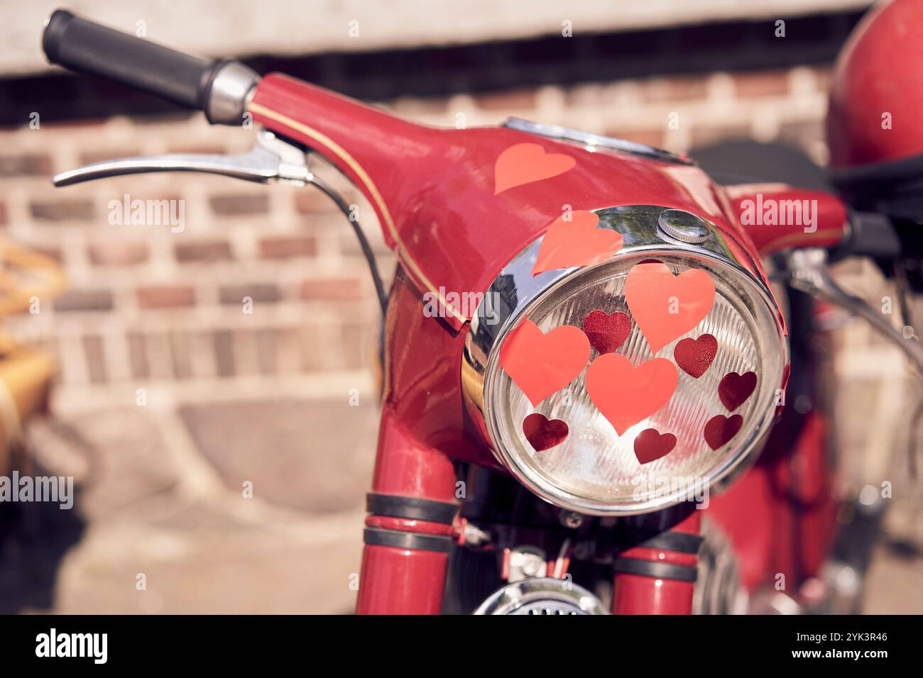 Vintage scooter handlebars on urban street, showcasing retro and ...