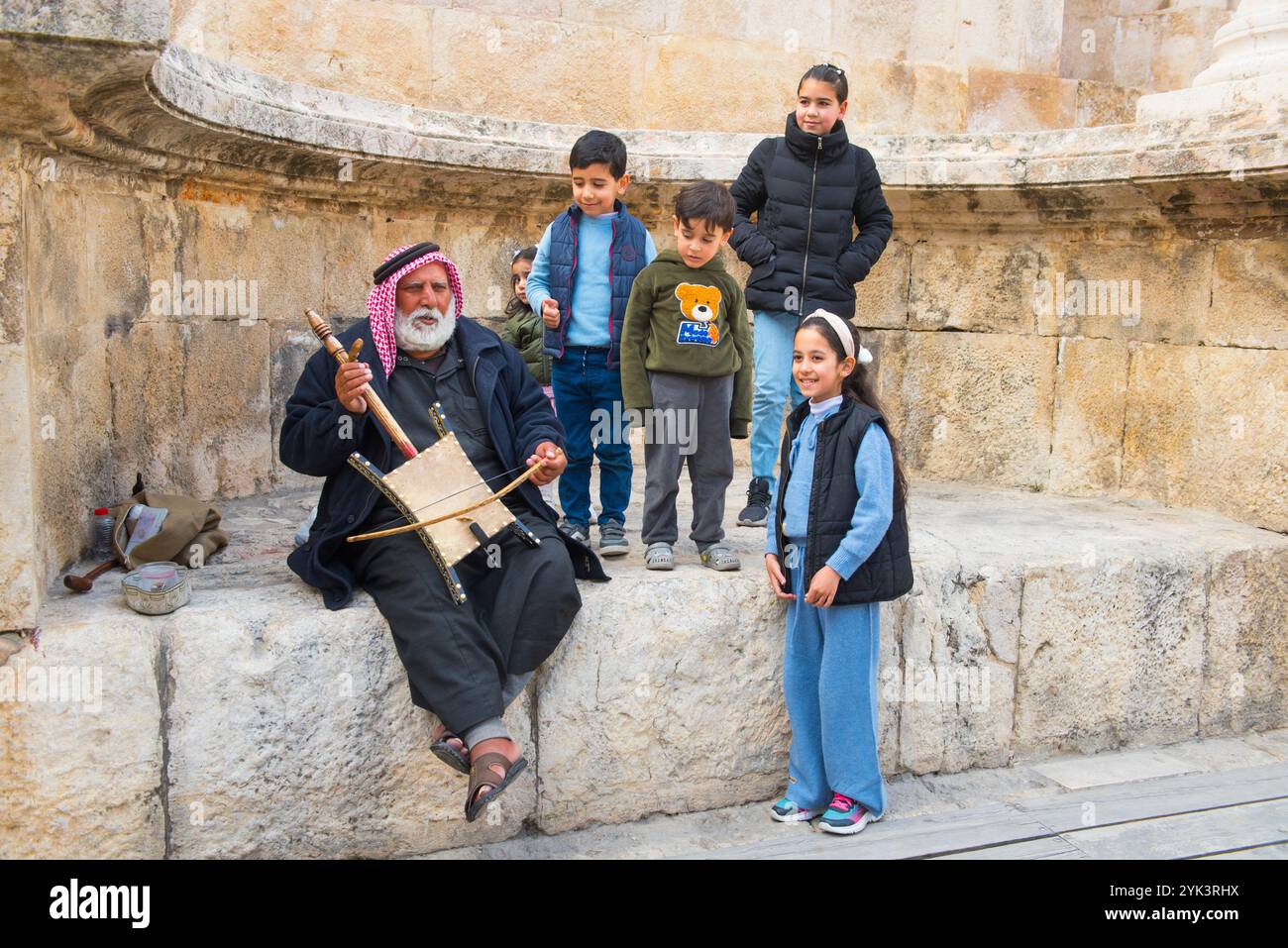 Old man playing "Rebab" at the Roman Theatre of Amman, Jordan, Near ...