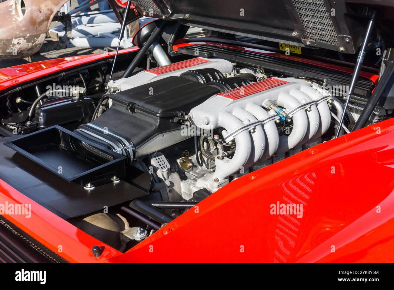 Close up detail of the Tipo F113 flat-12 engine in a rosso corsa red ...