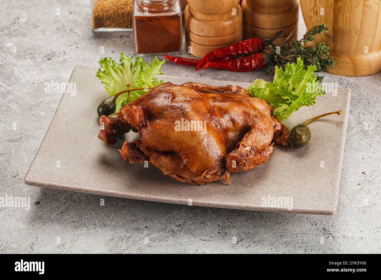 Baked whole small chicken with spices Stock Photo - Alamy