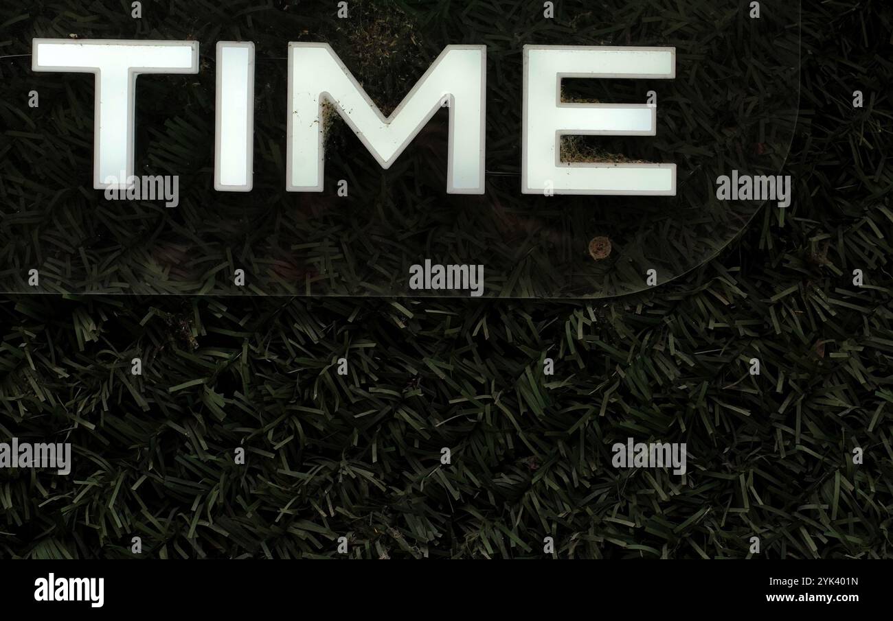 Neon Signage "Time" on Grass: A Life is Short Reminder Stock Photo - Alamy
