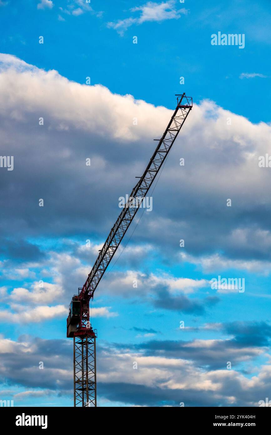 A towering construction crane lifting materials at a building site ...