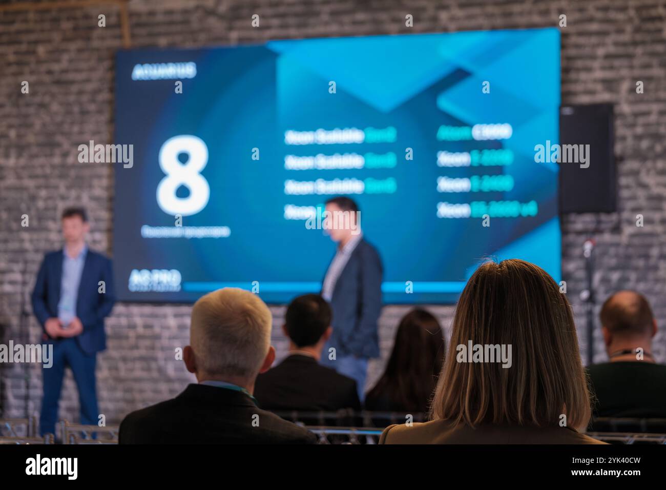 Professional presentation featuring large digital screen in ...