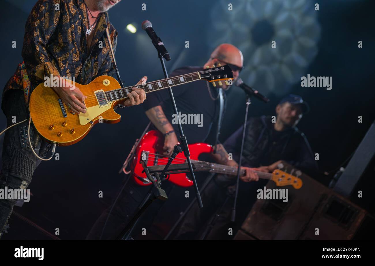 Musicians performing live rock concert with electric guitars on stage ...