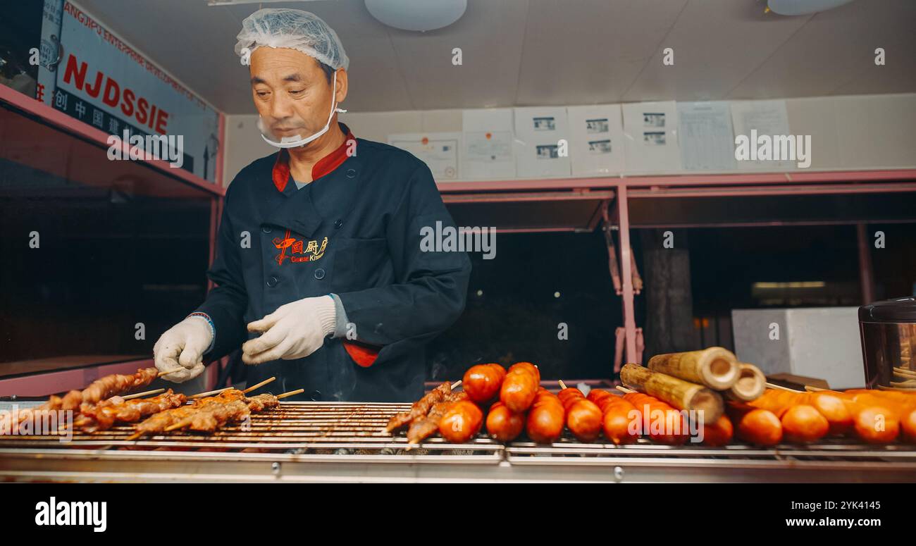 Beijing, China. Man Vendor Of Traditional Chinese Meat Snack On Bamboo ...