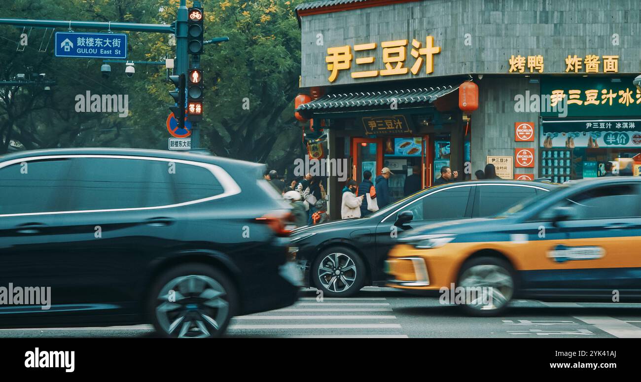 Beijing, China. Traffic On Gulou East Street In Beijing. Many Electric ...
