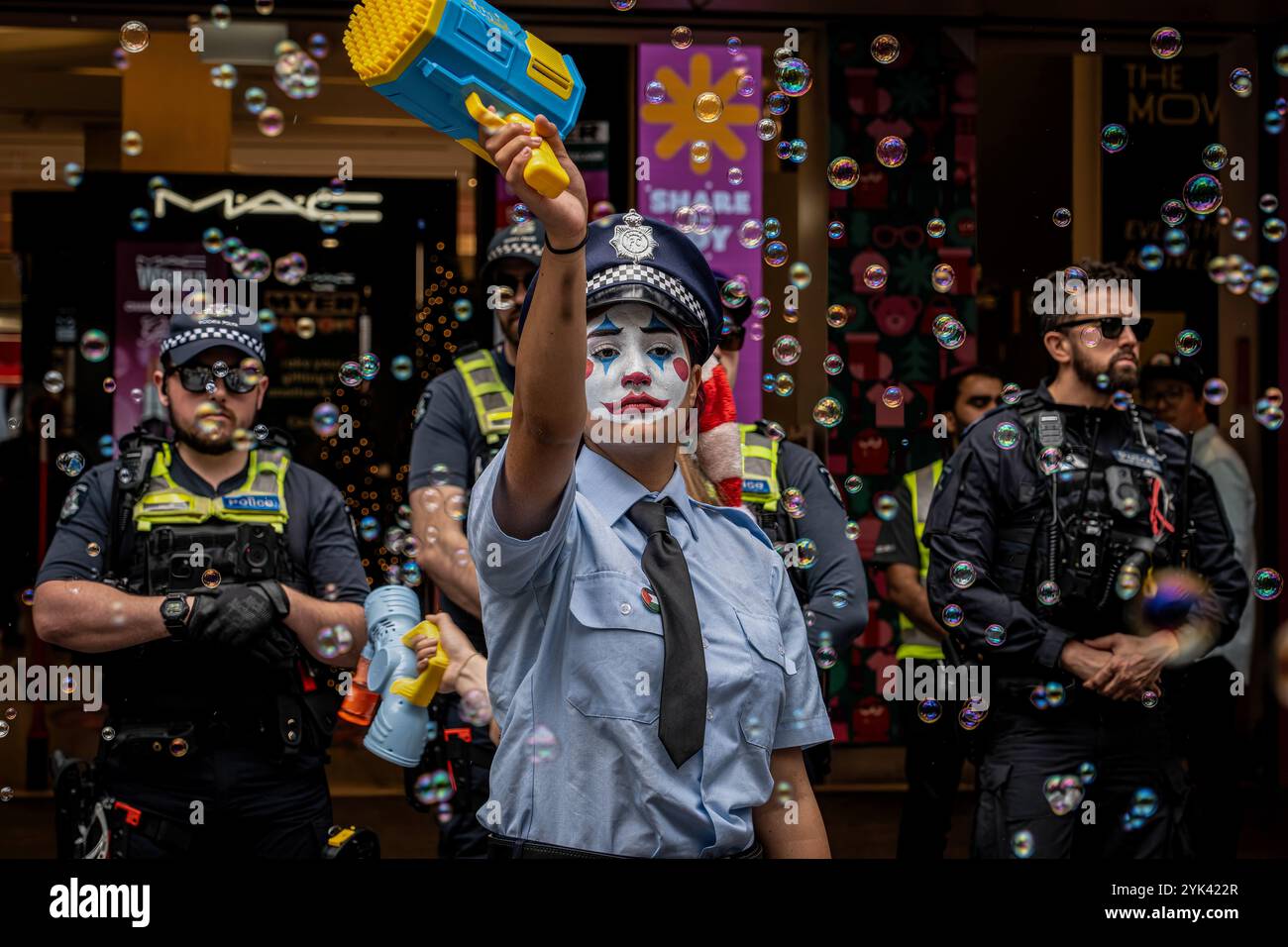 A demonstrator dressed as a police officer with clown makeup on seen ...