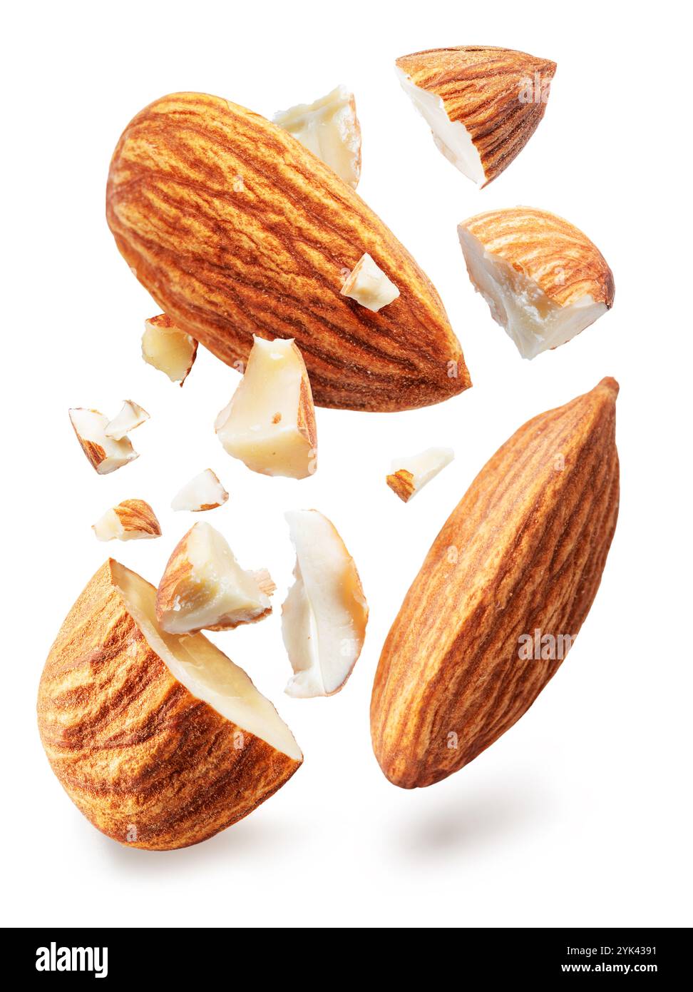 Almond nut split in half, pieces of almond nut levitating in air ...