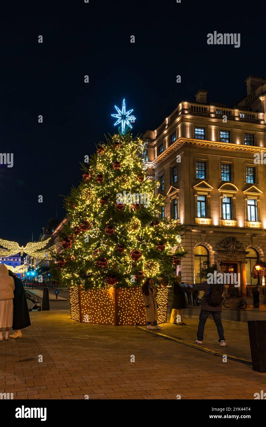 LONDON - NOVEMBER 15, 2024: Beautiful Christmas tree at Waterloo Place ...