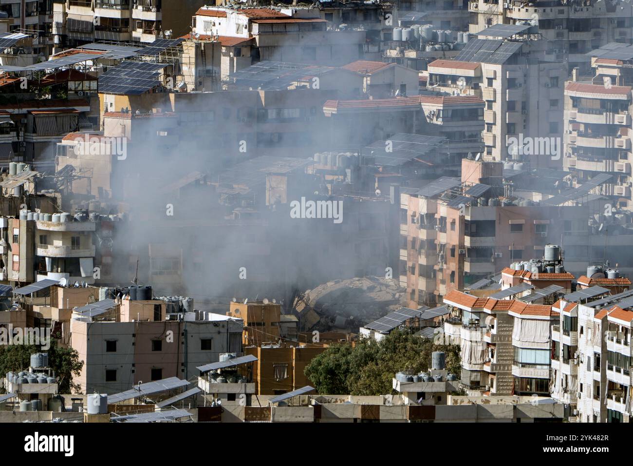 Smoke rises from buildings following an Israeli airstrike in Dahiyeh ...