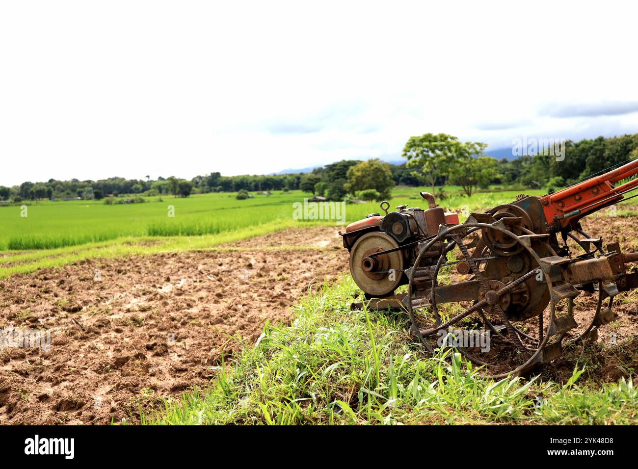 Tractor-Image of traditional farming equipment in a rural green field ...