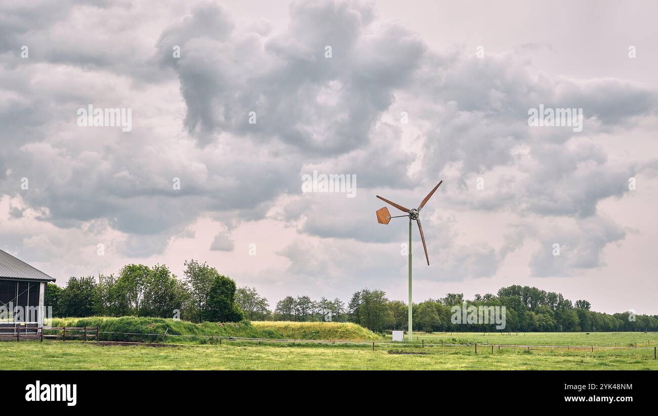A rural Dutch landscape featuring a small EAZ wind turbine, green ...