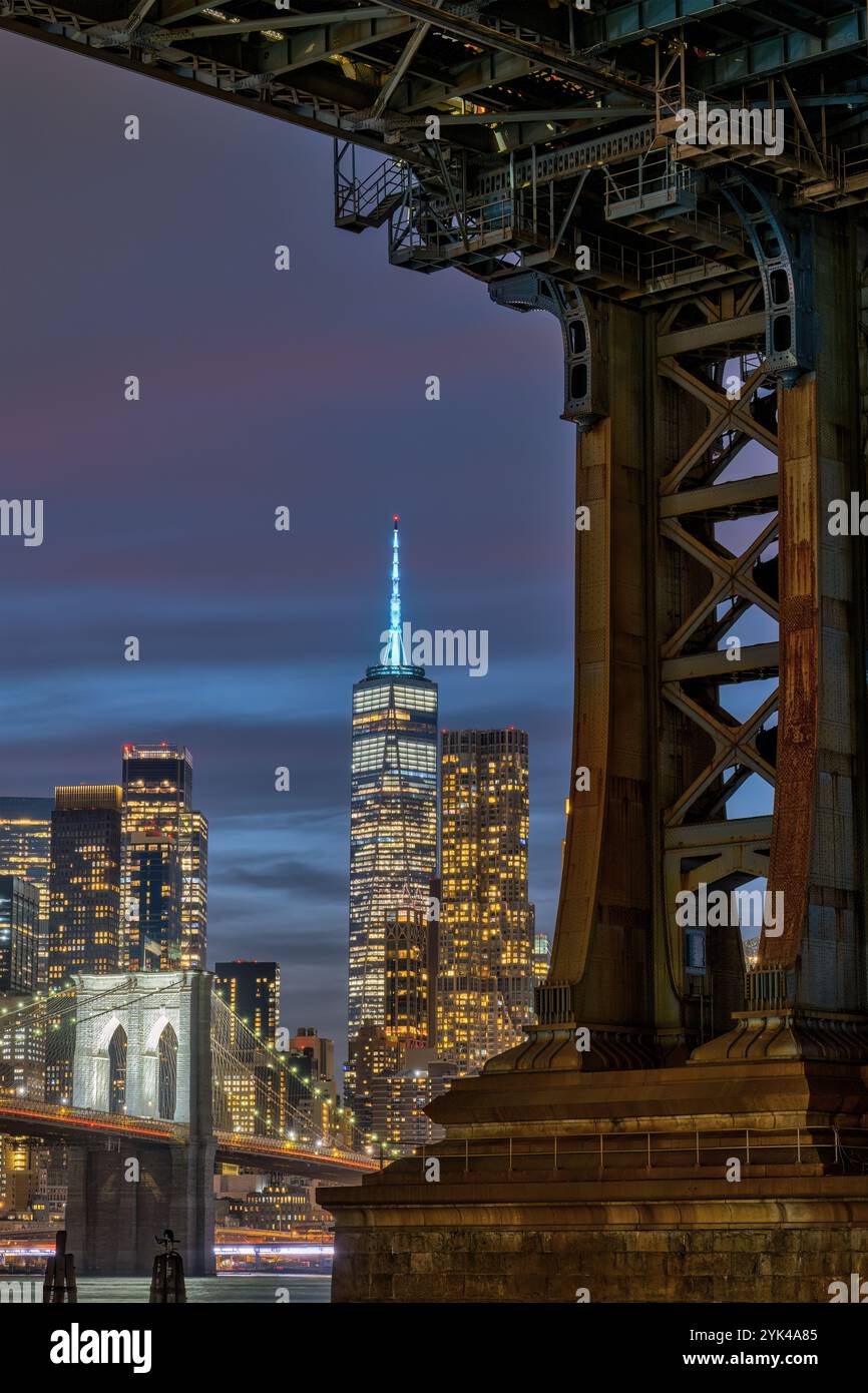 The famous Brooklyn Bridge at night seen with one of the bridge piers ...