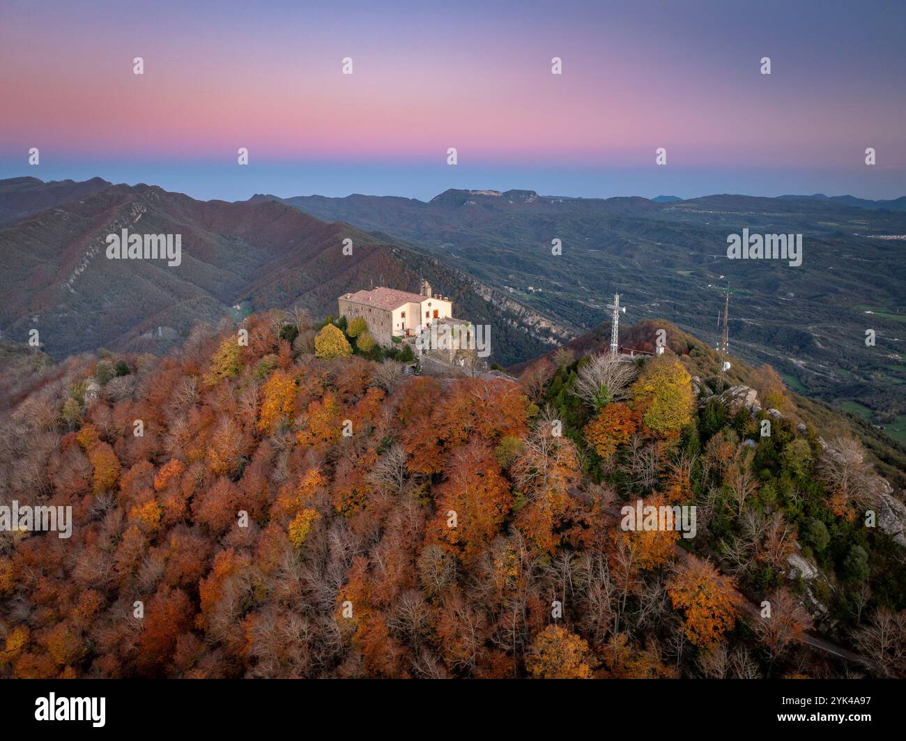 Aerial view of the Bellmunt mountain range and sanctuary, on an autumn sunset with the ochre ...