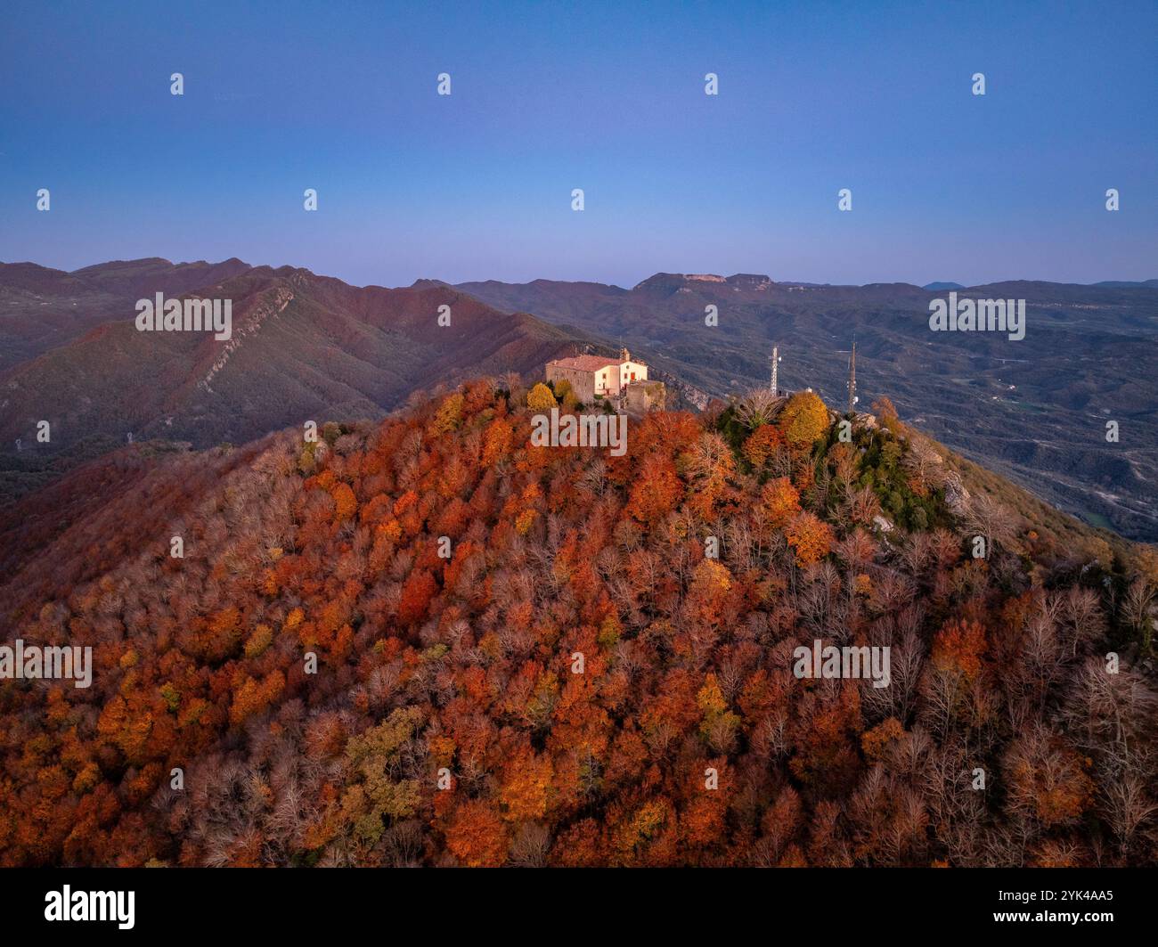 Aerial view of the Bellmunt mountain range and sanctuary, on an autumn sunset with the ochre ...