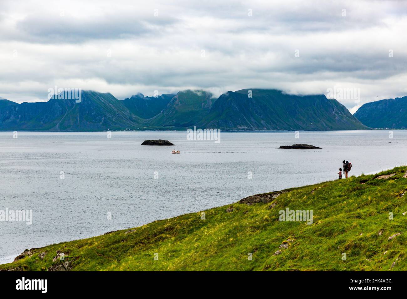A father, son, and daughter hike in Roren, Lofoten, Norway, with ...
