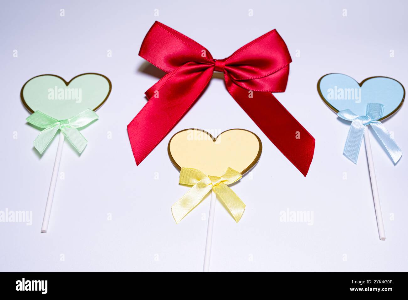 valentine concept using a red ribbon and small three ribbons on ...