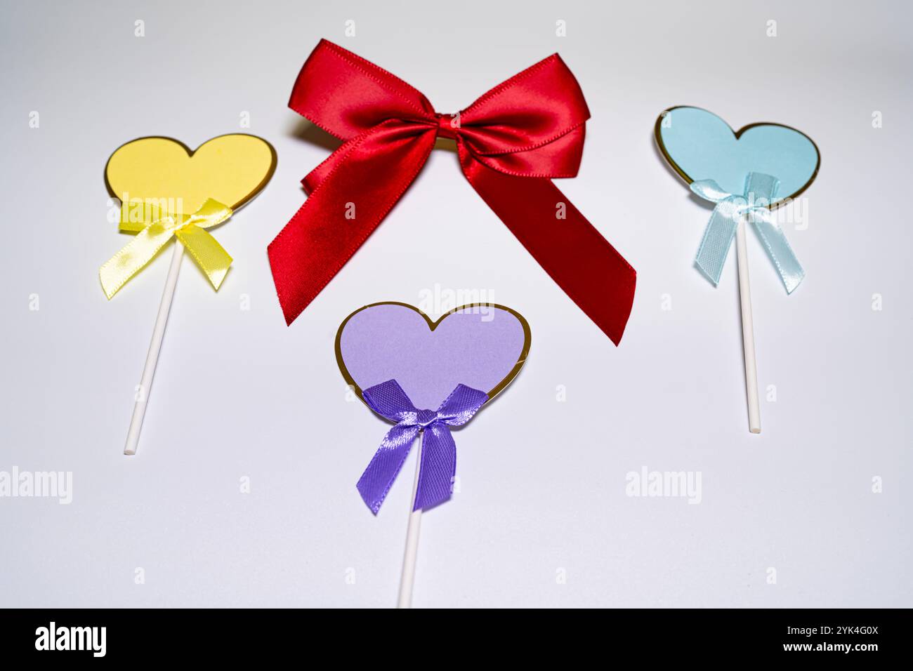 valentine concept using a red ribbon and small three ribbons on ...