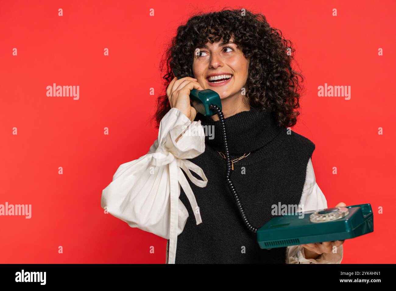 Hey you, call me. Caucasian young woman with curly hair talking on ...