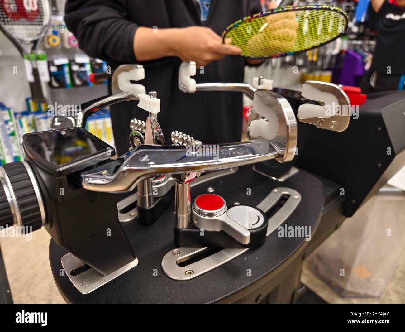 Strings a badminton racket on a racket stringing machine Stock Photo - Alamy