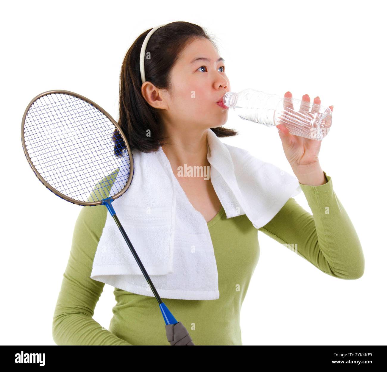 Drinking water after playing badminton Asian woman drinking water after ...