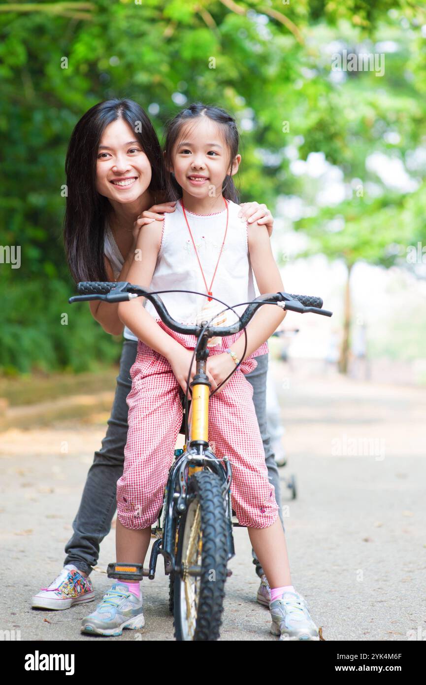 Asian family riding bike Asian parent and child riding a bike Copyright ...