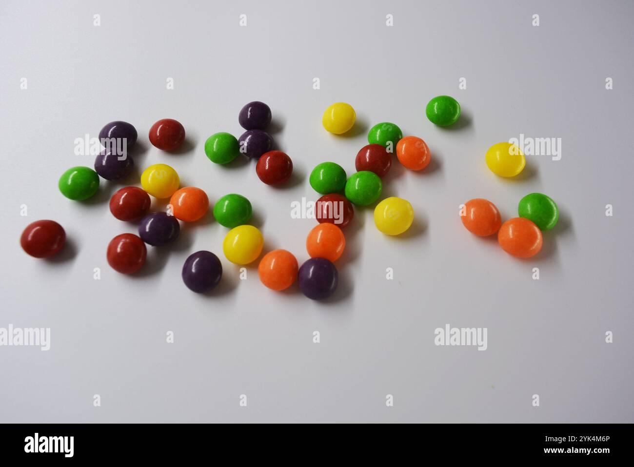 Beautiful, bright chewing and chocolate candies covered with sugar ...