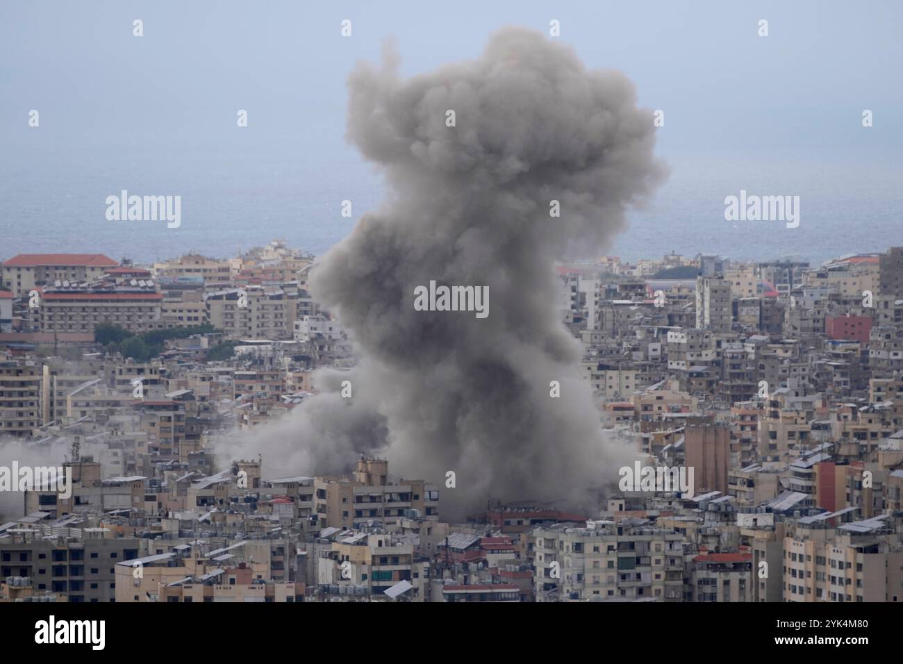 Smoke rises between buildings hit in a Israeli airstrike in Dahiyeh, in ...