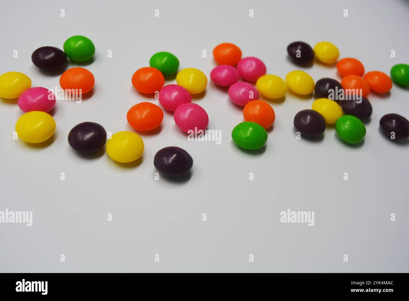 Beautiful, bright chewing and chocolate candies covered with sugar ...