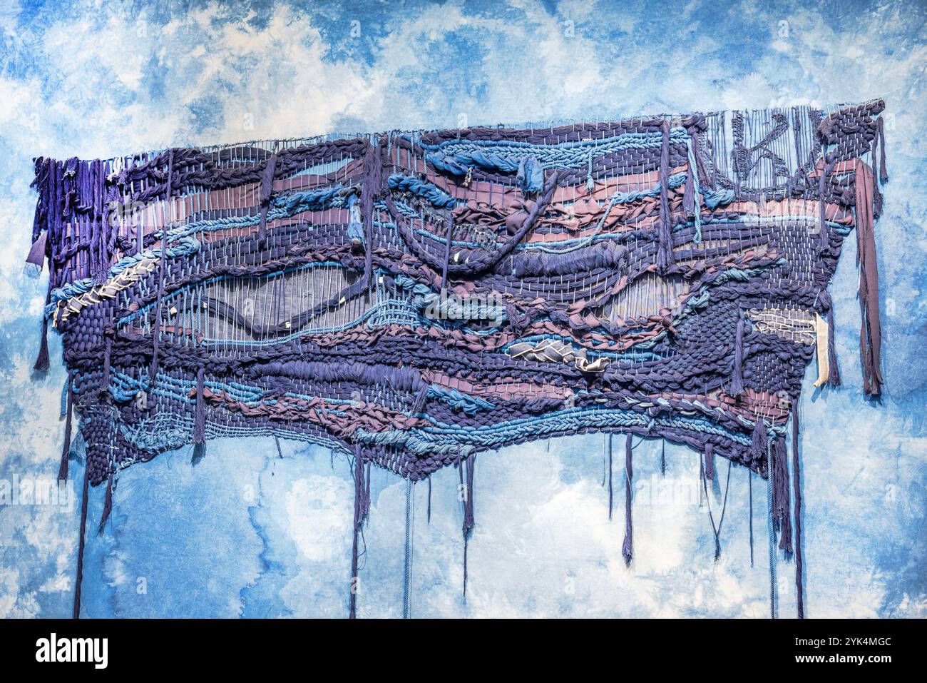 Intricate blue and purple textile artwork with woven and knotted ...